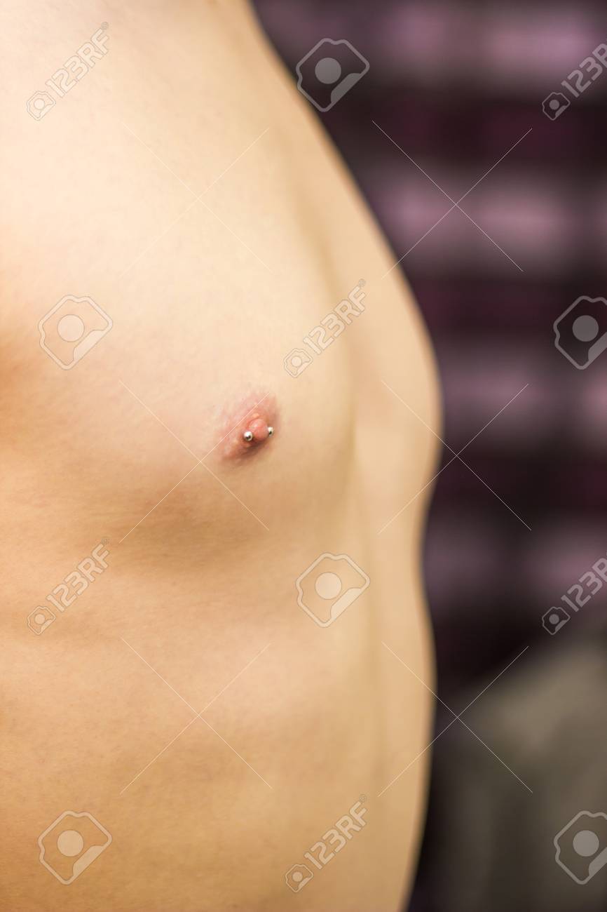 Pierced Male Nipple With Steel Straight Barbell Close up Shallow Depth Of Field Stock Photo Picture and Royalty Free Image. Image 77604411