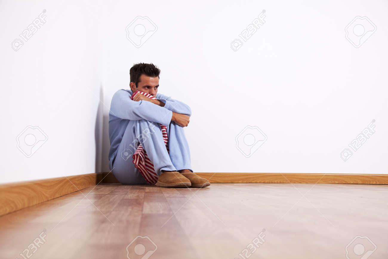 Young Man With Nightclothes Sit At The Room Corner With Fear Stock Photo Picture and Royalty Free Image. Image 16384311