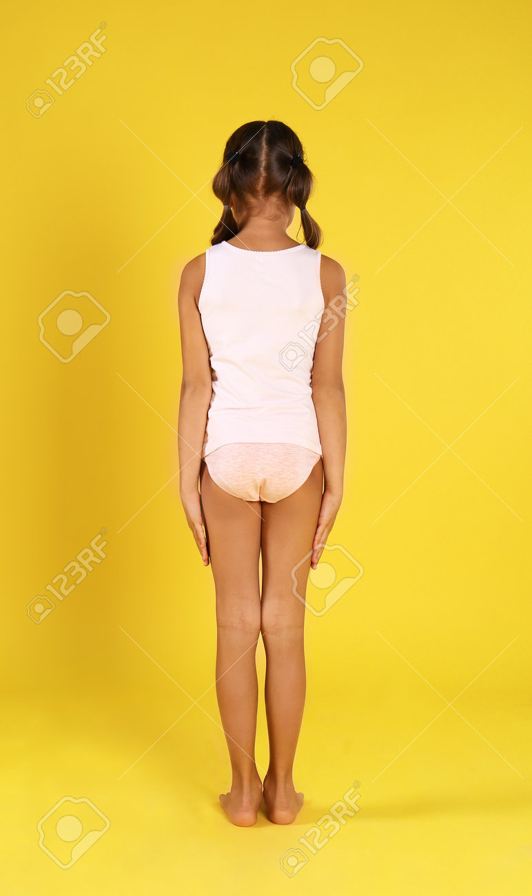 Little Girl In Underwear On Yellow Background Back View Stock Photo Picture and Royalty Free Image. Image 196509540