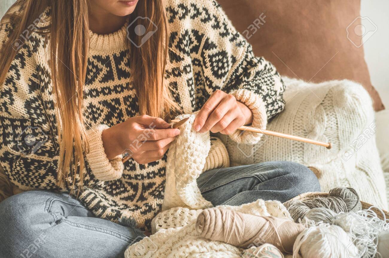 Beautiful Girl Knits A Warm Sweater On The Bed. Knitting As A Hobby. Accessories For Knitting. Stock Photo Picture and Royalty Free Image. Image 130201710
