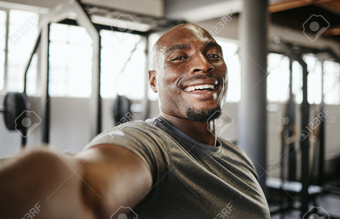 Selfie Fitness And Black Man Training Doing A Workout And Cardio In The Gym Young Portrait And African Athlete Sweating In A Photo After Exercise For Health Body Strength And Sport At
