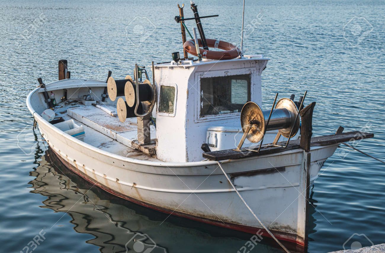 Unused Small Fishing Boat In Port With Worn Hull. Old Fishing Boat Waiting For Any Job Empty Deck Stock Photo Picture and Royalty Free Image. Image 146722533