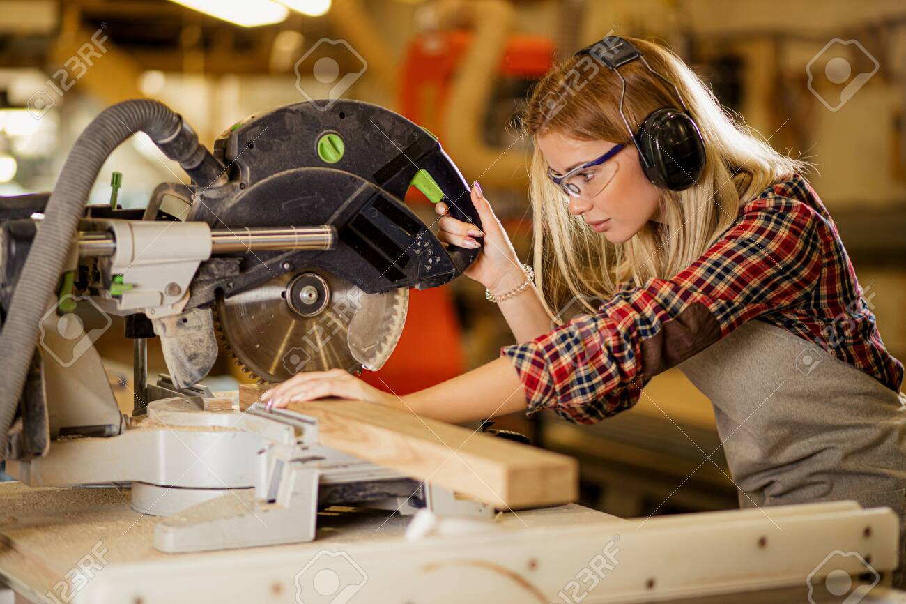 Concentrated Woman Carpenter Behind Powerful Electric Machine Woman Use Circular Sawer For Wood Cutting Stock Photo Picture and Royalty Free Image. Image 145561611