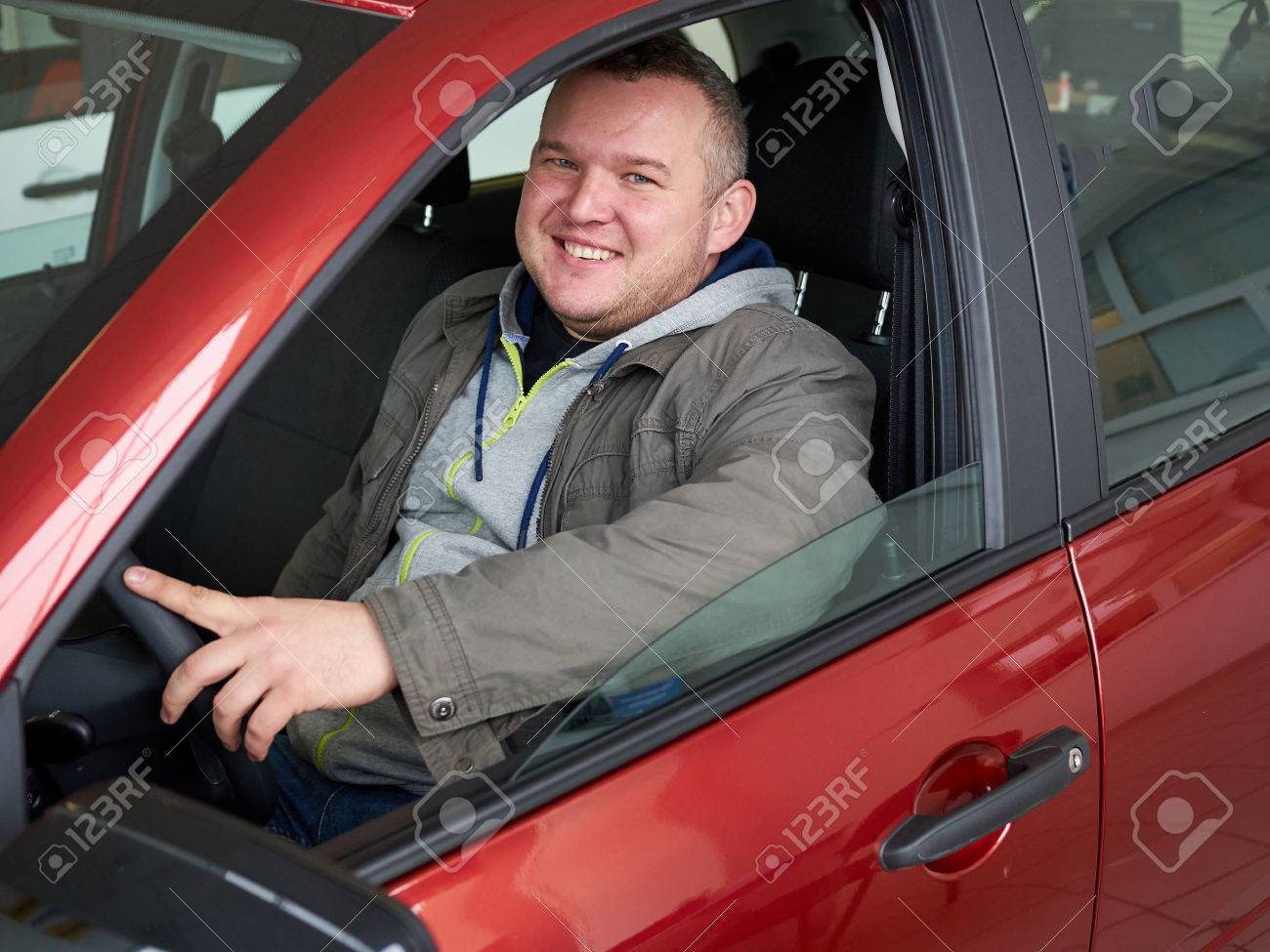 Fat man in car store